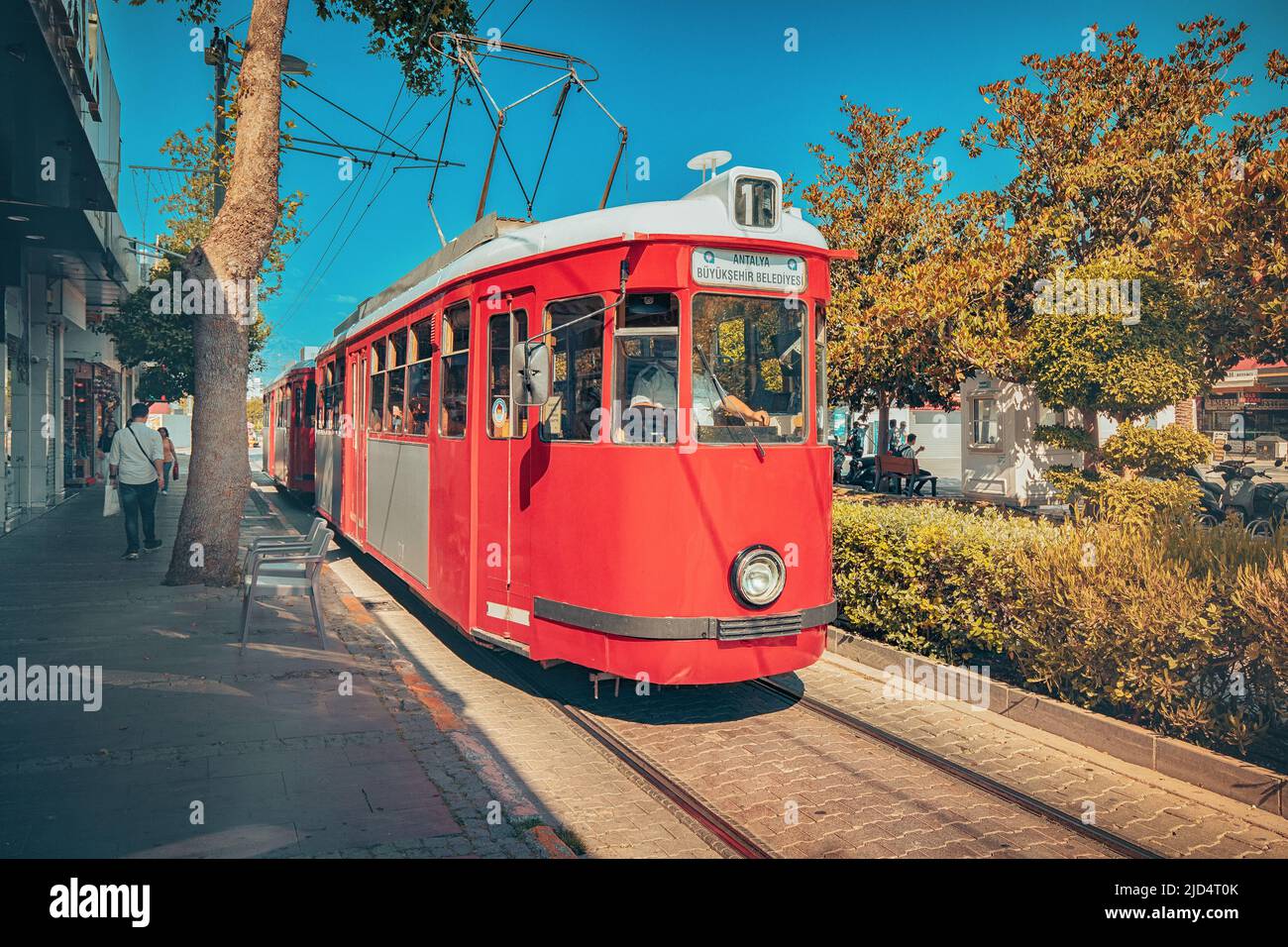 18 May 2022, Antalya, Turkiye: Red retro tram driving on the streets of ...