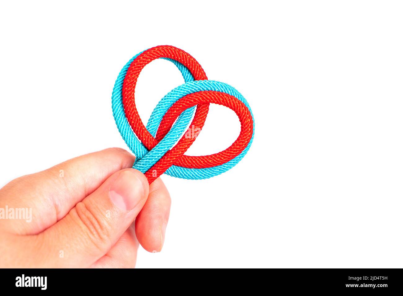 Hand holding a heart shape made of two intertwined cords isolated on a ...