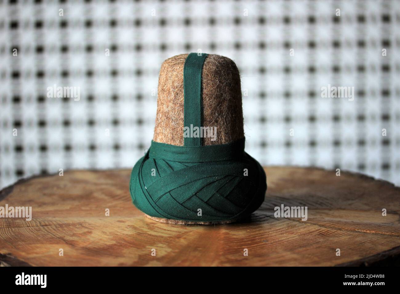 A hat made of felt worn by the whirling dervishes. The brown hat worn ...