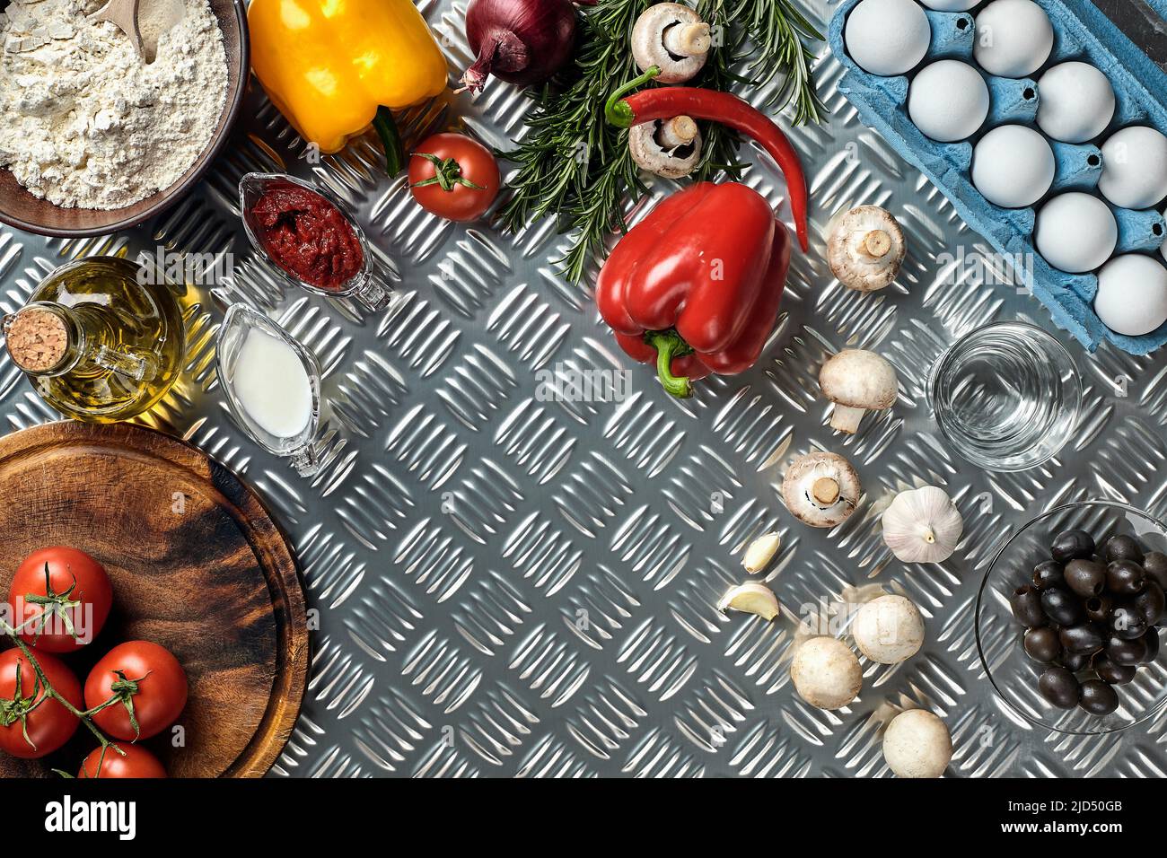 Cooking Pizza. Pizza ingredients on the iron table with copy space, top ...