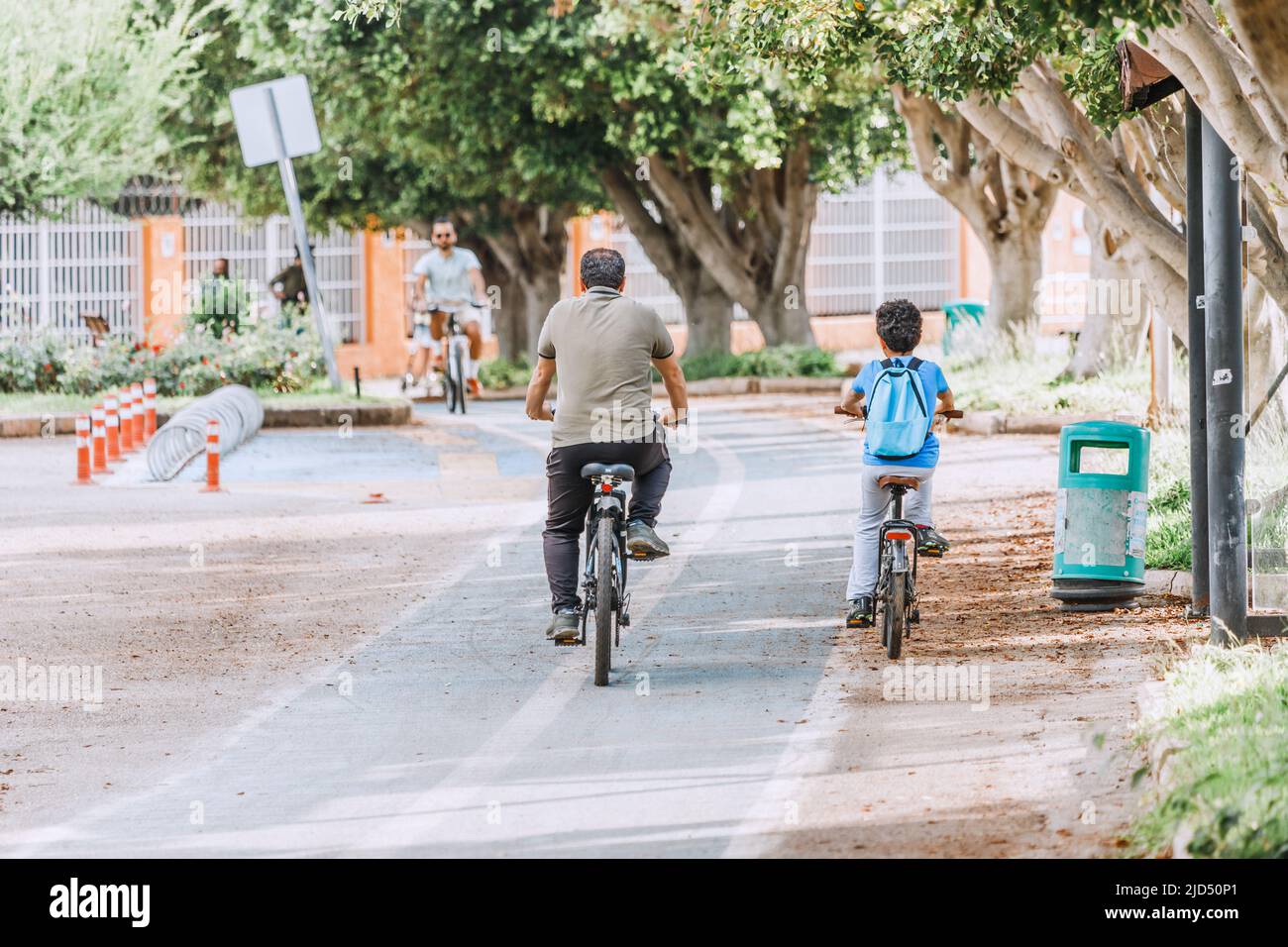 19 May 2022, Antalya, Turkey: Cyclists Dad and son ride along a bike ...