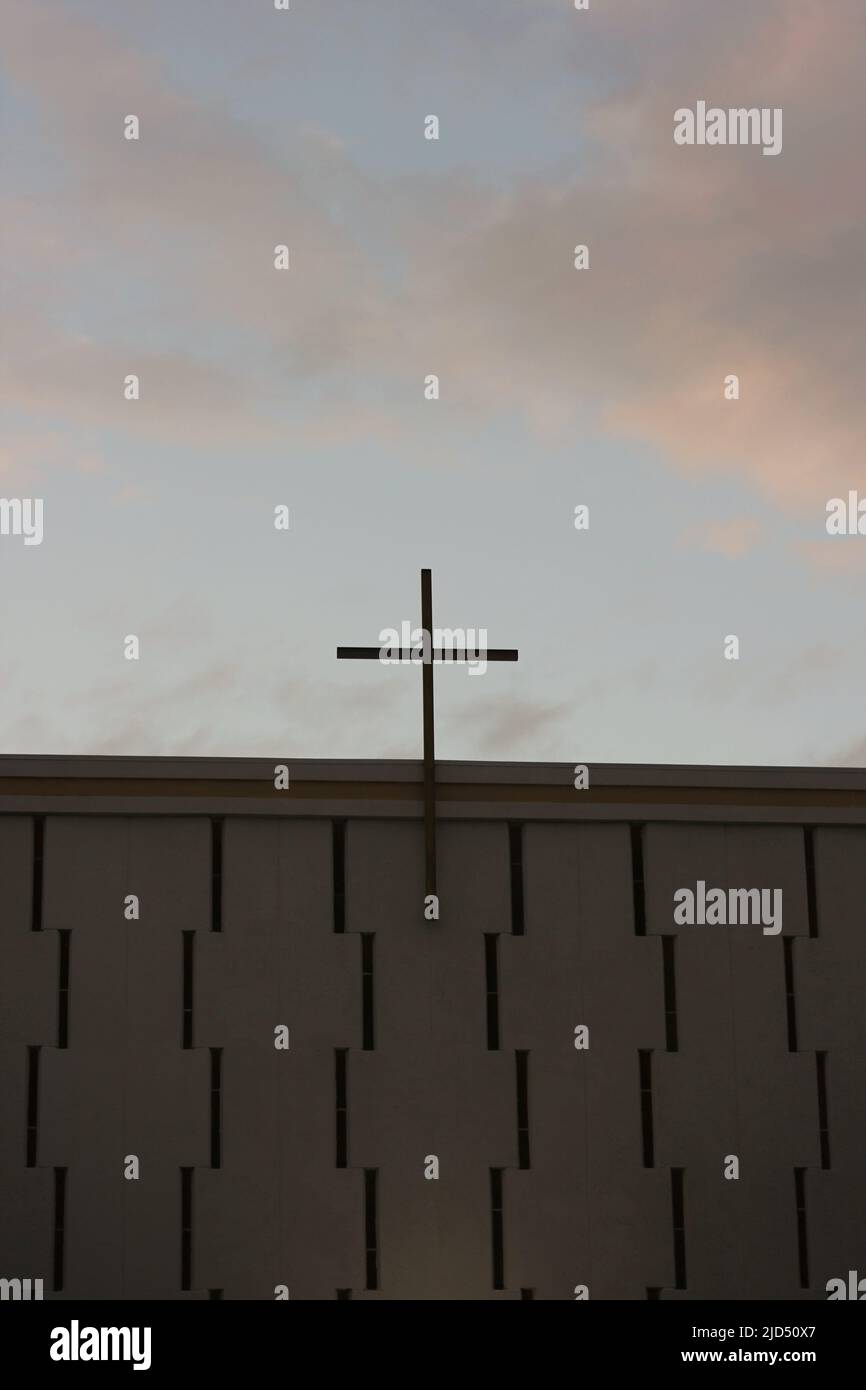 A simple Christian cross standing on top of a church Stock Photo - Alamy