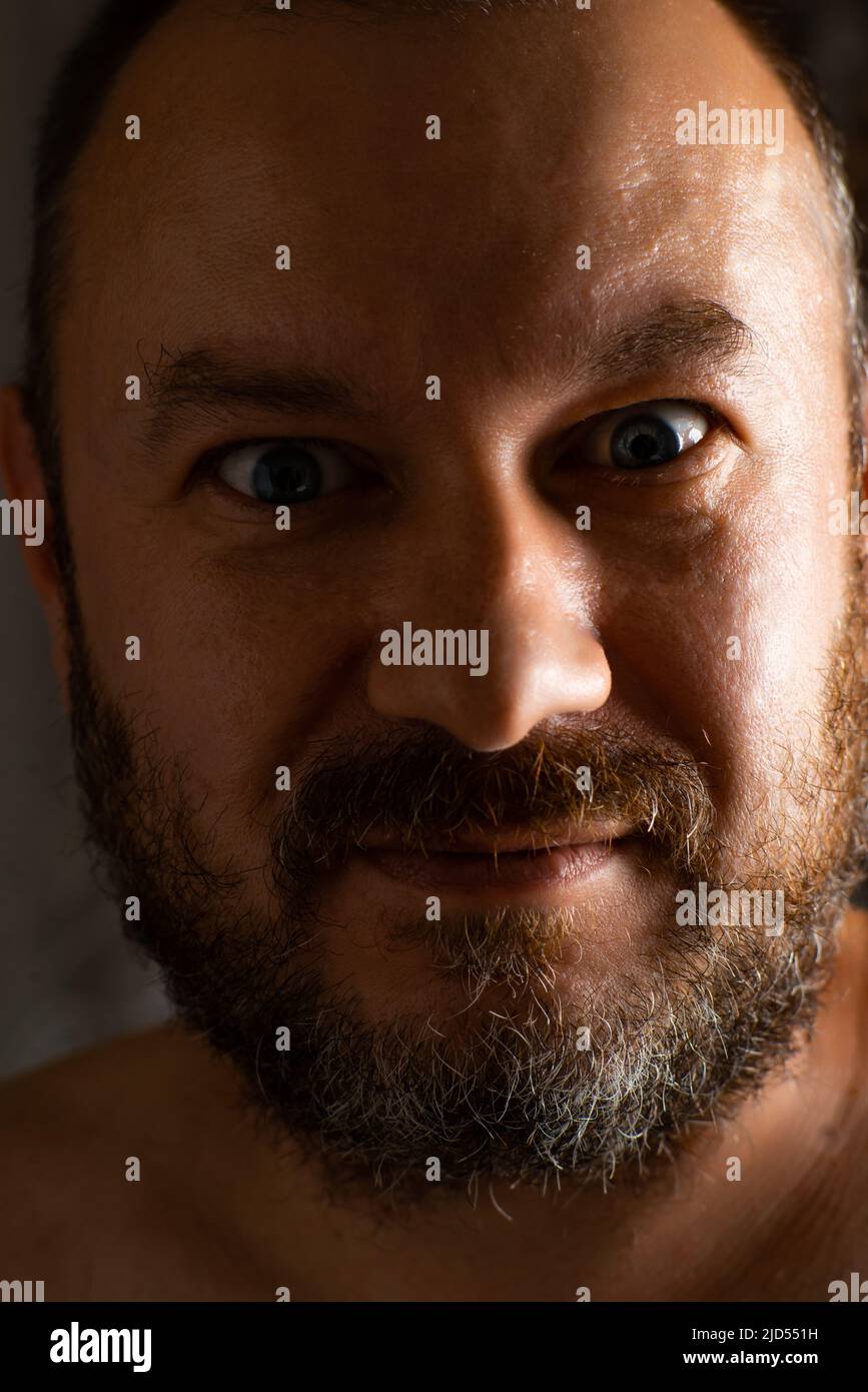 Portrait of an ordinary middle-aged man unshaven in the dark Stock ...