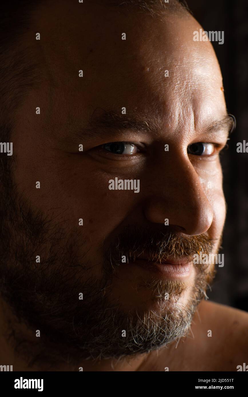 Portrait of an ordinary middle-aged man unshaven in the dark Stock ...