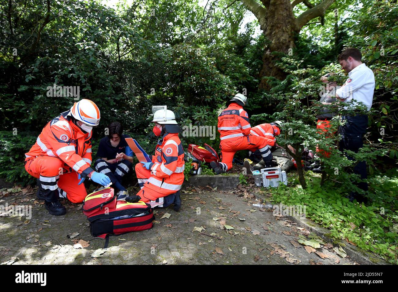 Essen, Germany. 18th June, 2022. First aiders treat injured people to ...