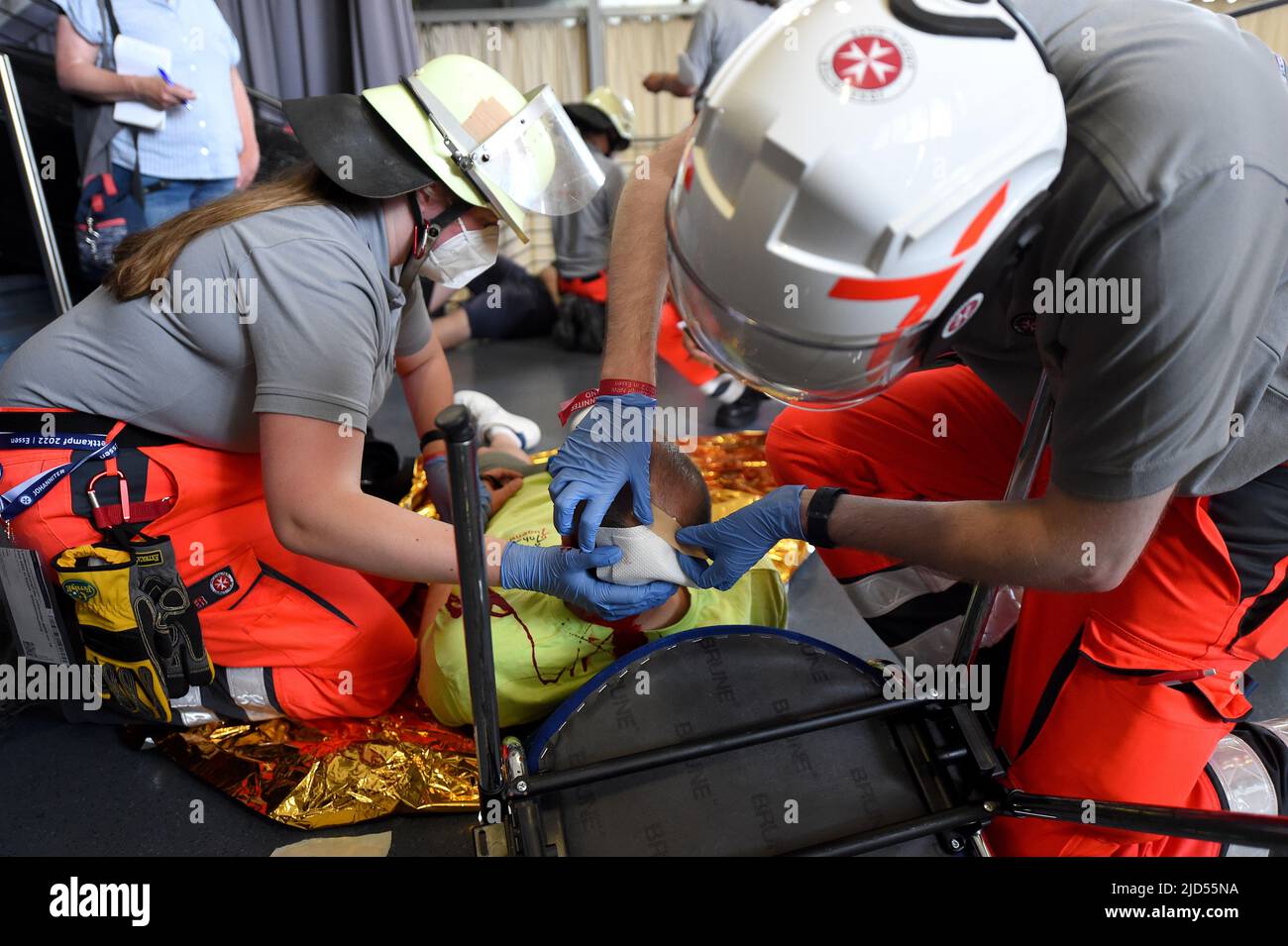 Essen, Germany. 18th June, 2022. First aiders treat injured people with ...