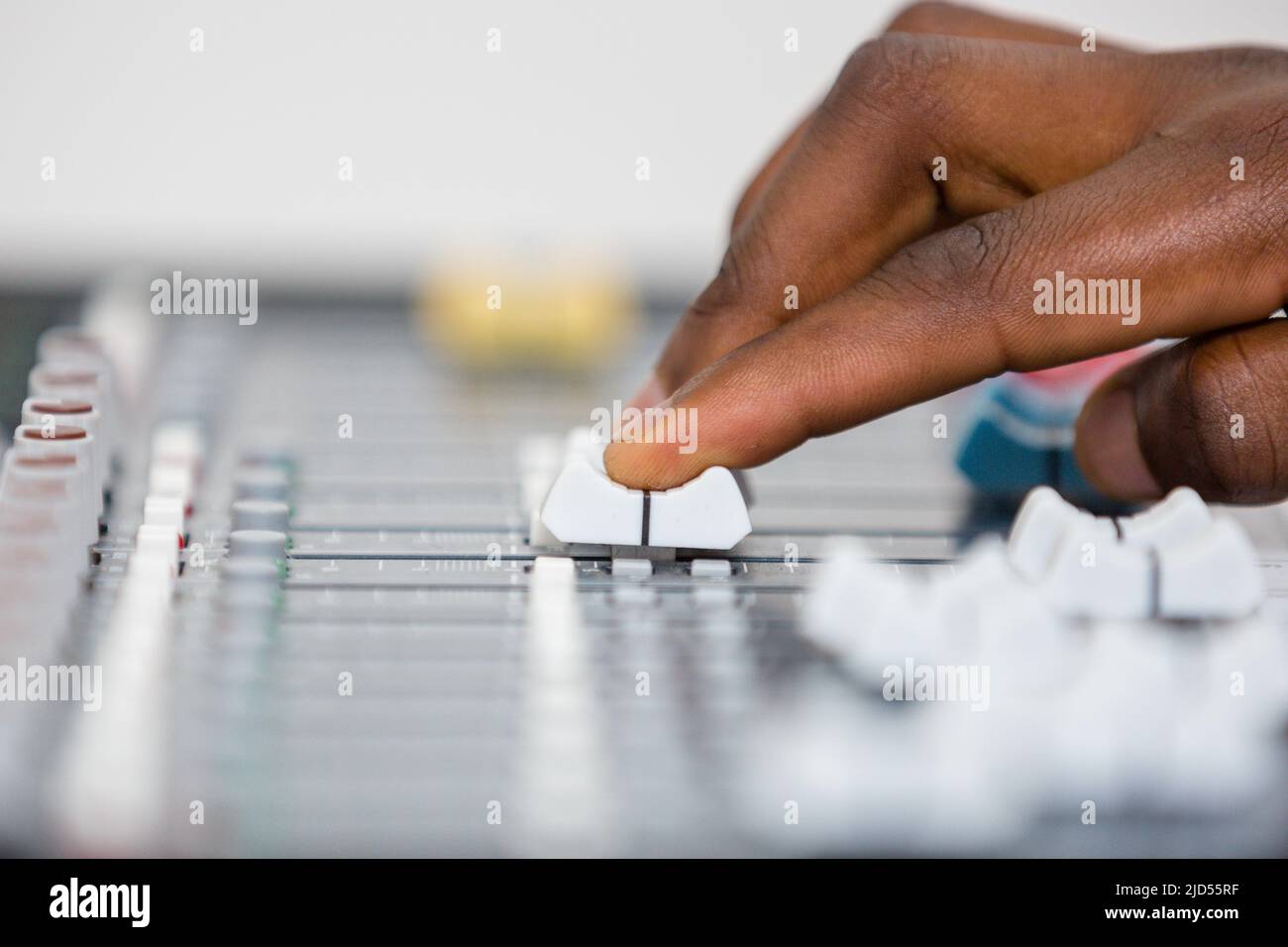 Audio sound mixing system equipment hands fingers adjusting buttons ...