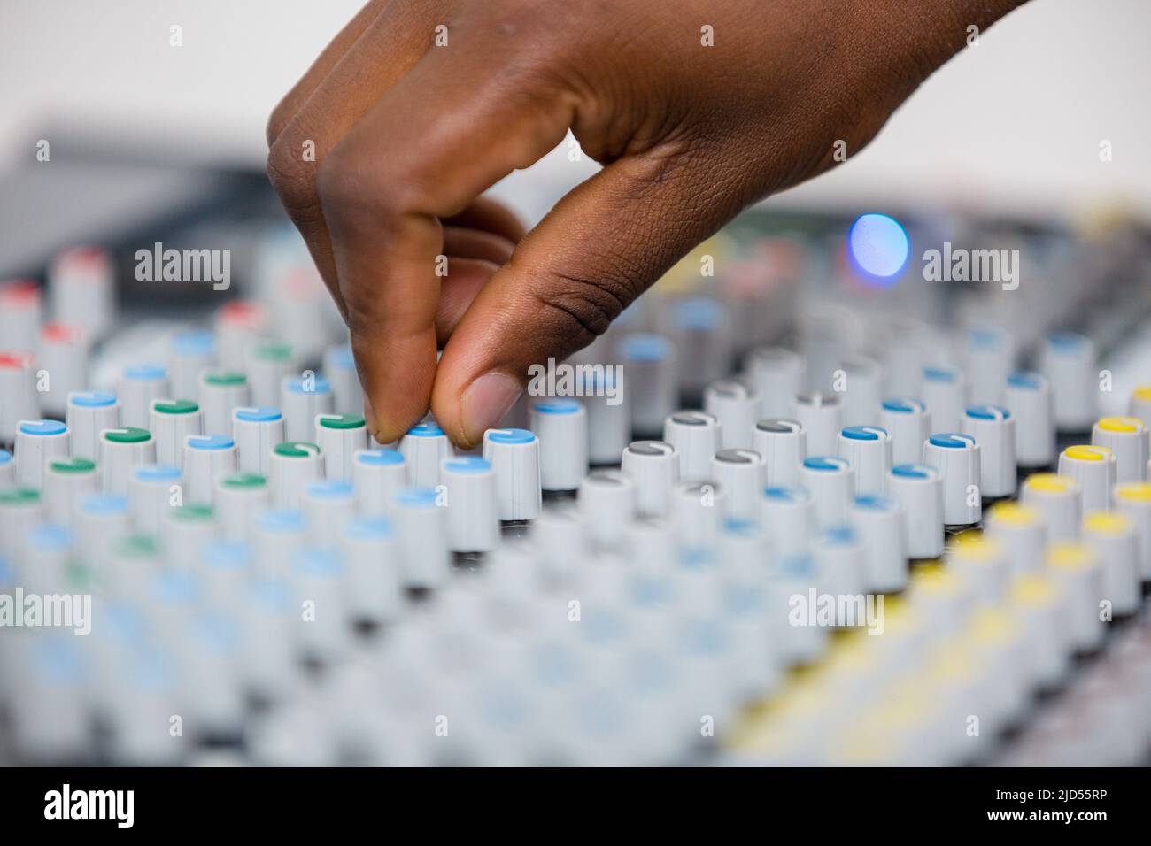 Audio sound mixing system equipment hands fingers adjusting buttons ...