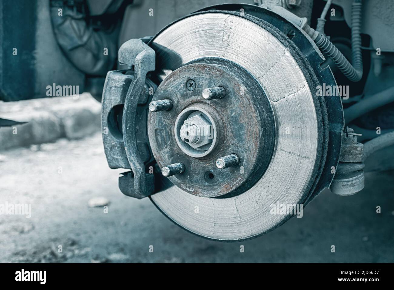 A rusty and old brake disc is serviced or replaced when the car is ...
