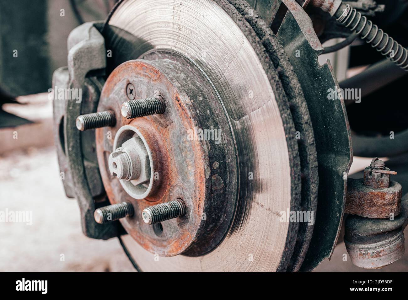 A rusty and old brake disc is serviced or replaced when the car is ...