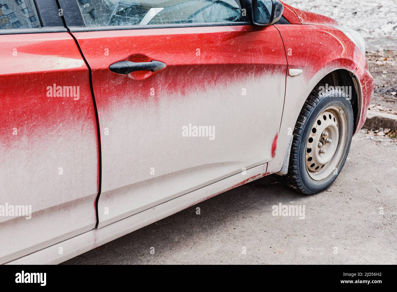 An unwashed and soiled battered car in the spring. The concept of road ...