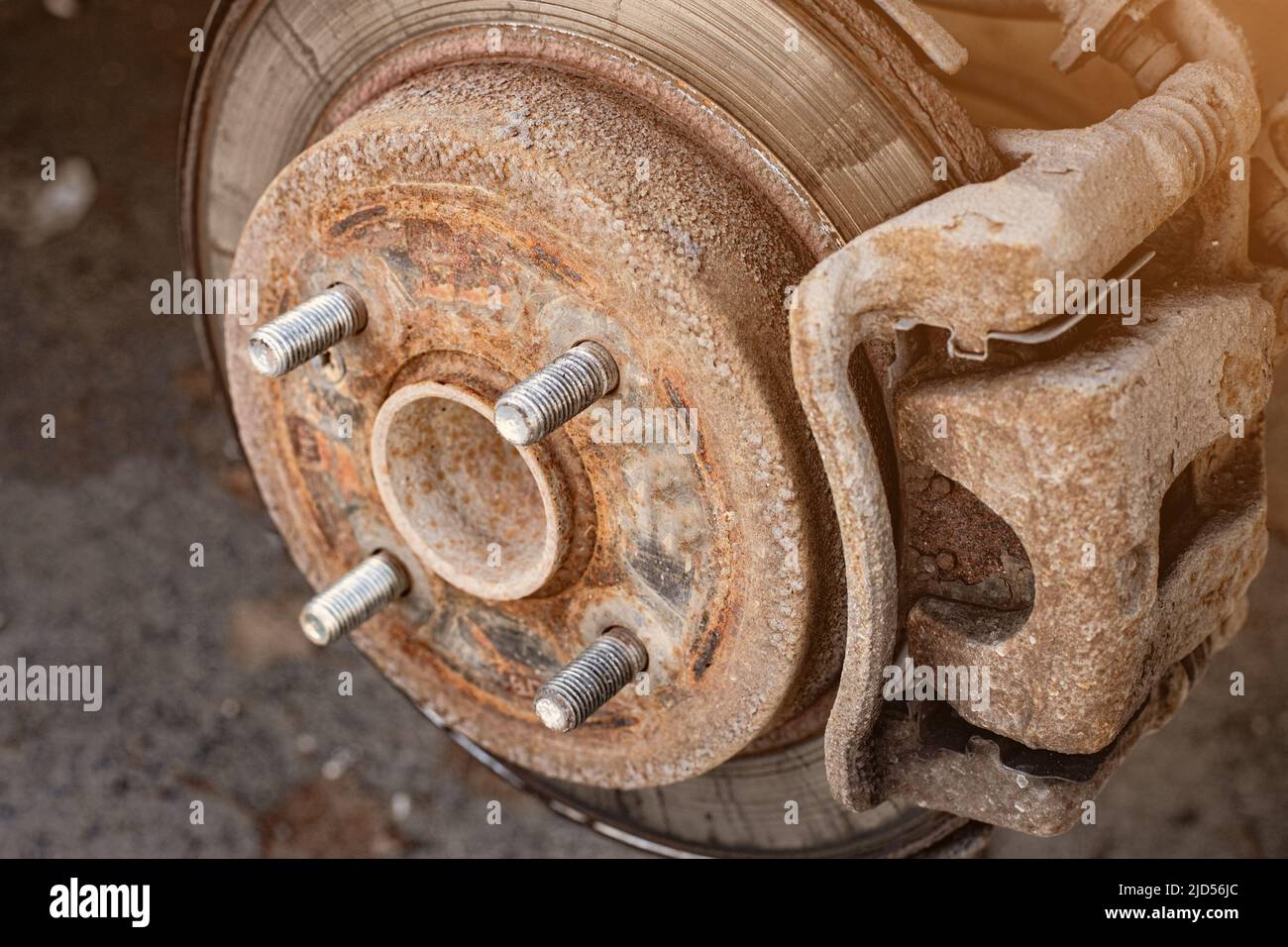 A rusty and old brake disc is serviced or replaced when the car is ...