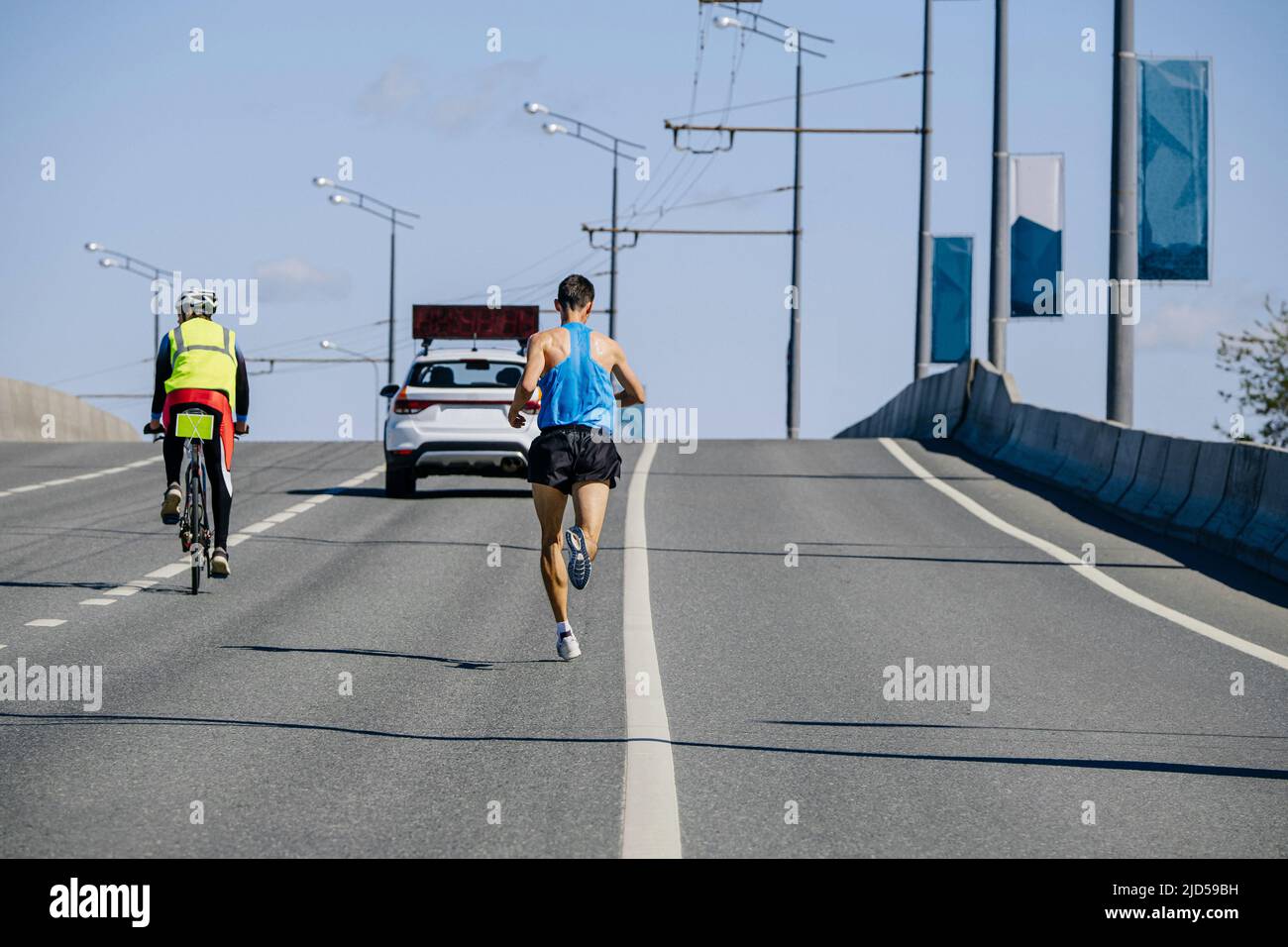 male runner leader run marathon. pace car ahead Stock Photo - Alamy