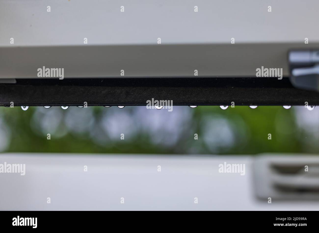 Falling raindrops from window frame of skylight during rain Stock Photo ...