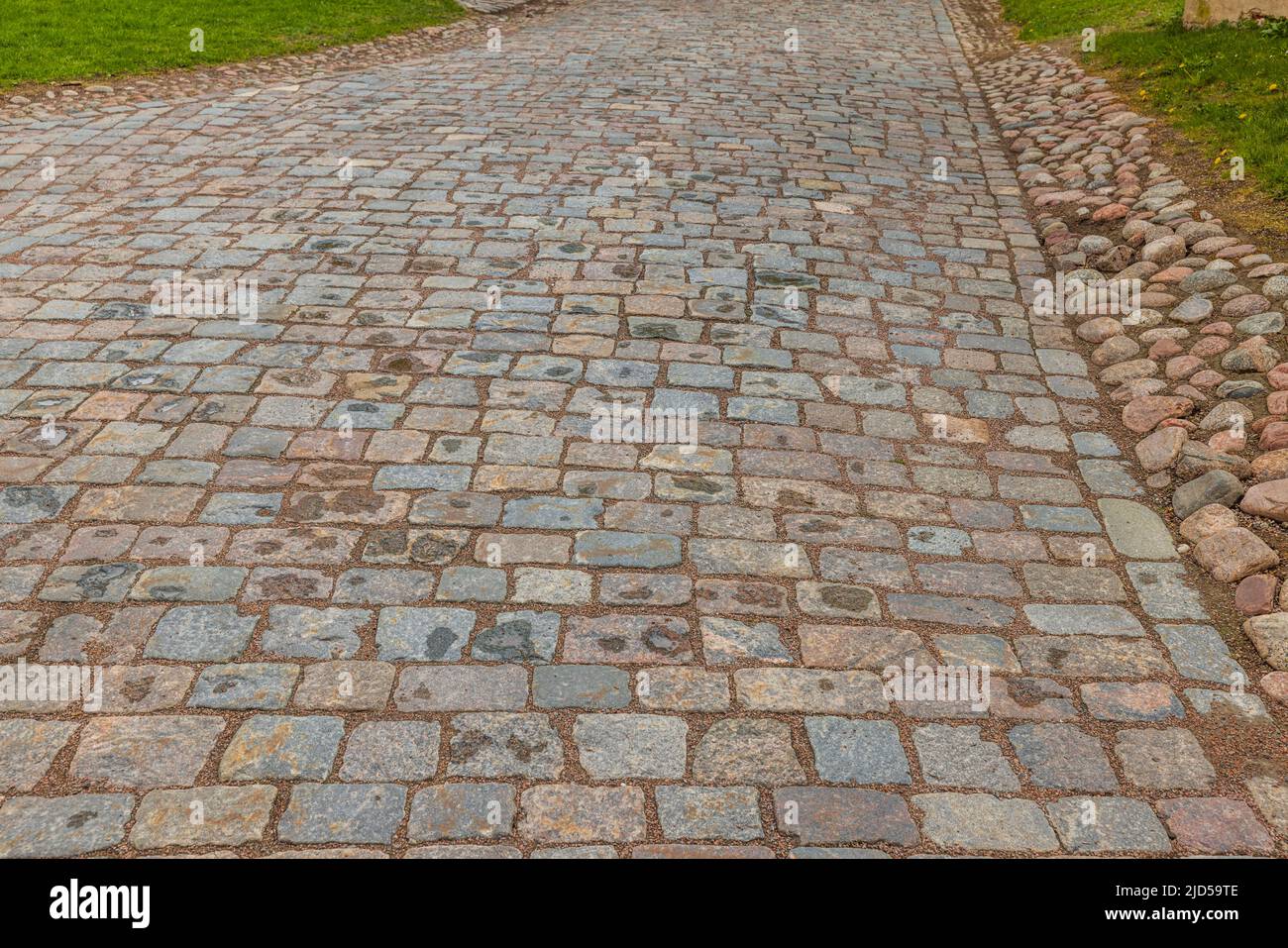 Beautiful view of pavement in park lined with old cobblestones. Sweden ...
