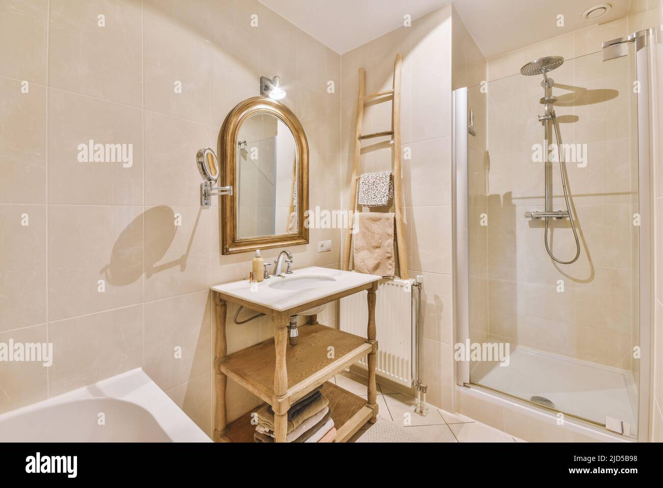 Sinks With Mirrors And Clean Bathtub Located Near Shower Box With Glass
