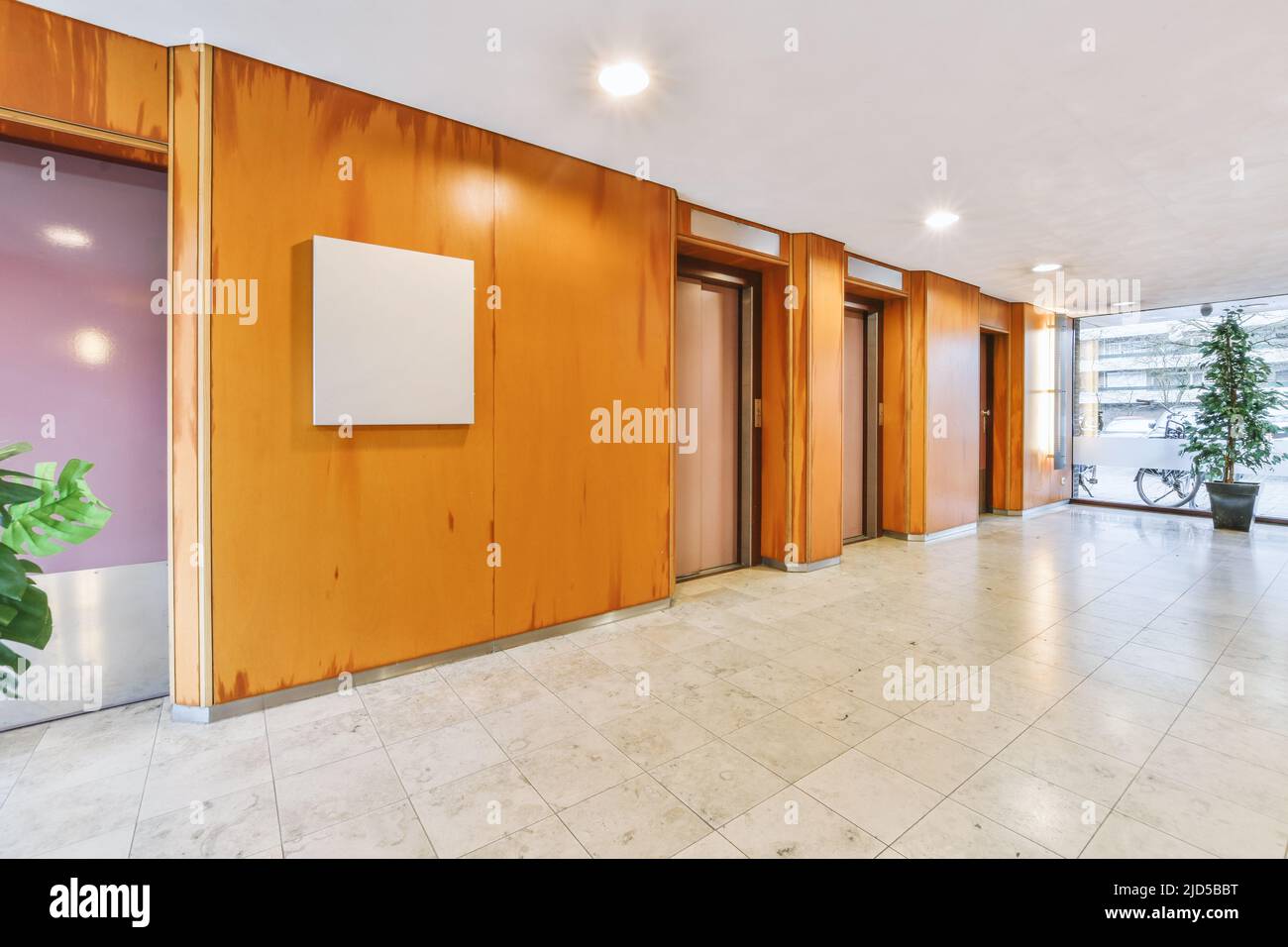 Shiny elevator with opened door located in illuminated hall of ...
