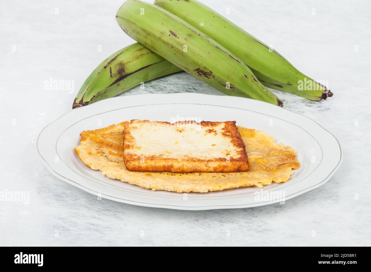 Fried plantain toston (patacon) with fried cheese Stock Photo - Alamy