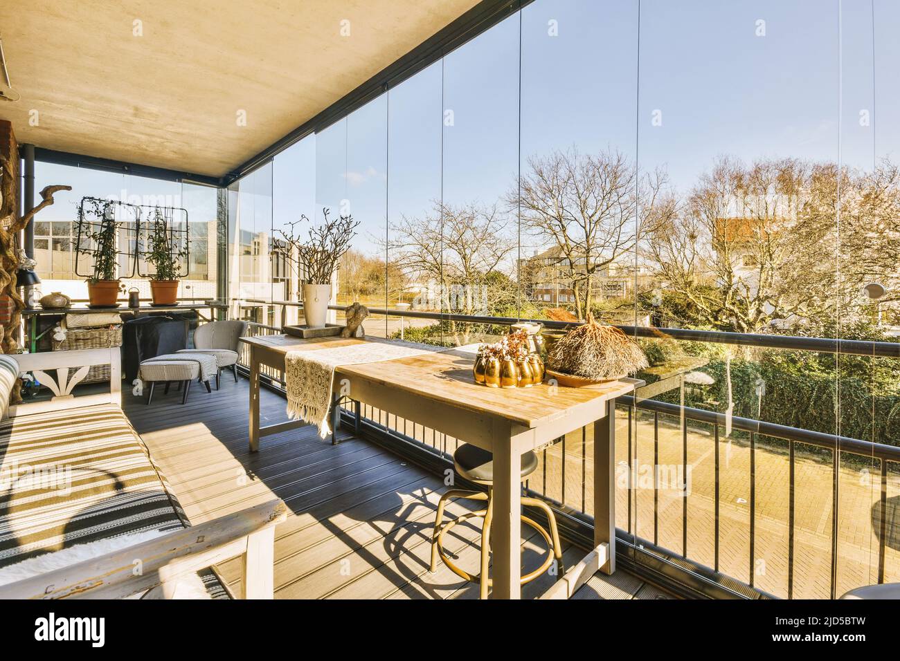 Narrow brick balcony with metal railings, wooden chair and door Stock ...