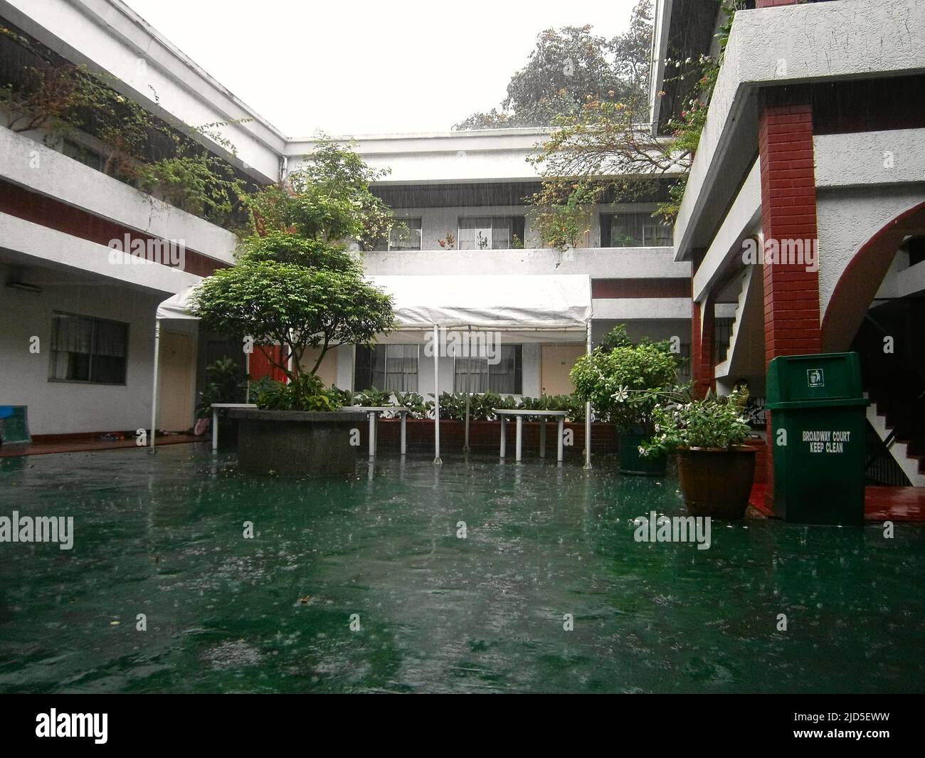 heavy rain falling in the courtyard garden of the Broadway Court ...