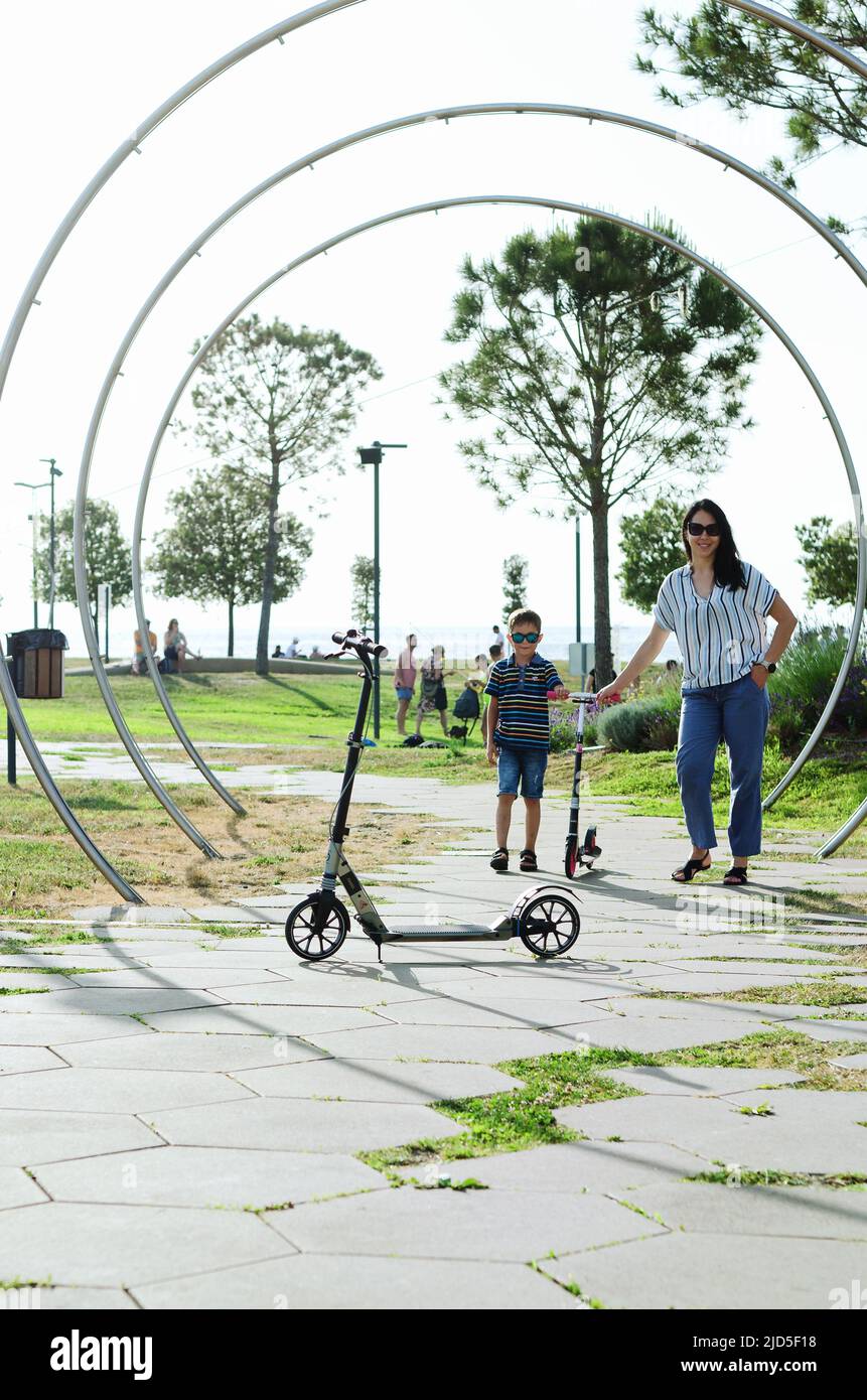 Happy family lifestyle and holiday concept. Mother, little boy riding ...