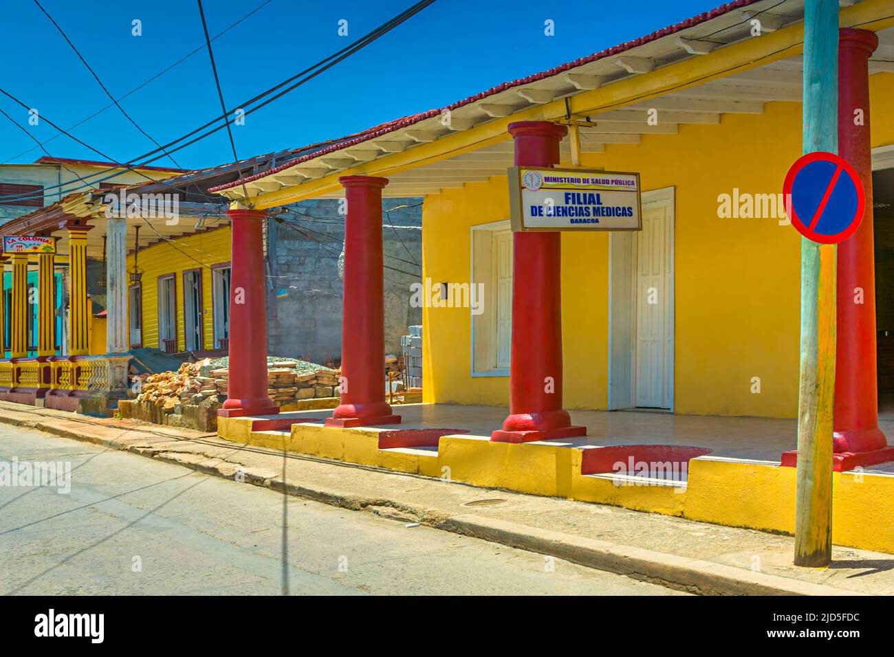 Red and yellow buildings in the streets of Baracoa, Cuba Stock Photo ...
