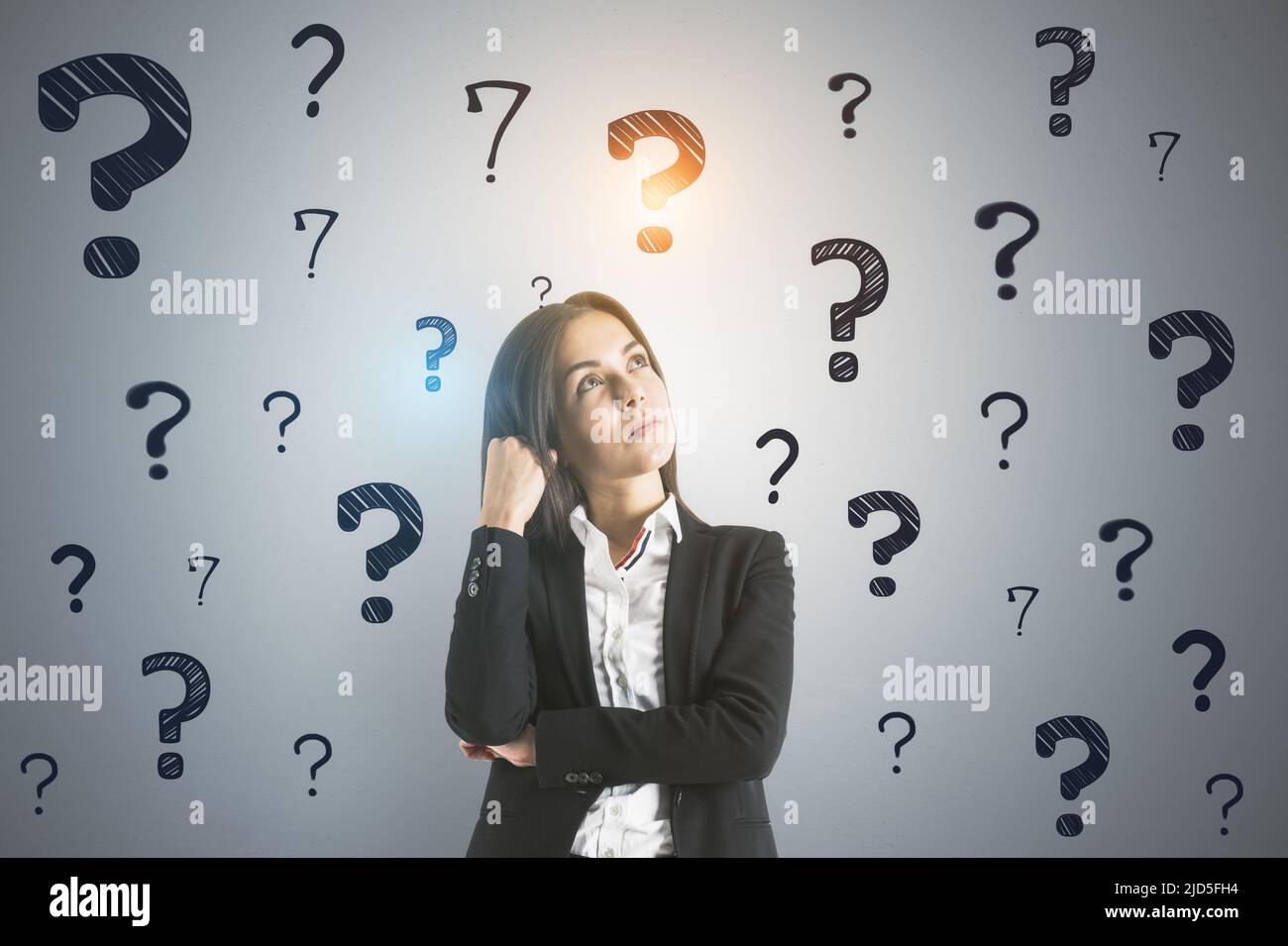Searching for an answer concept with pensive young businesswoman on ...