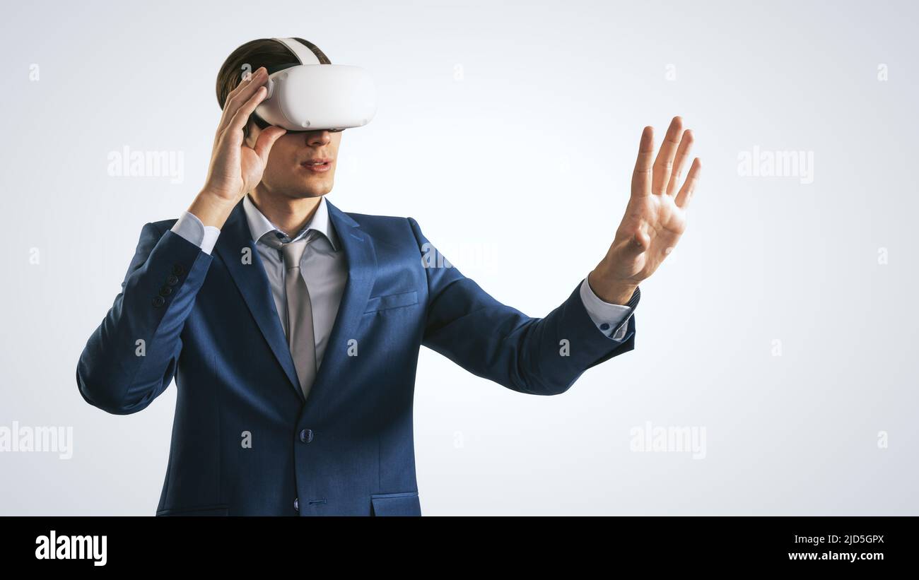 Young businessman working in virtual reality office in VR glasses ...