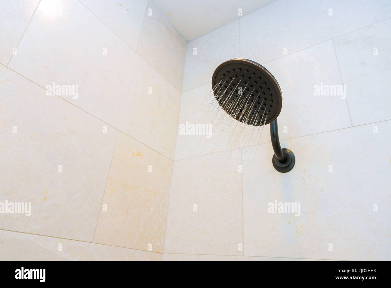 Water running from shower head of master bathroom Stock Photo - Alamy