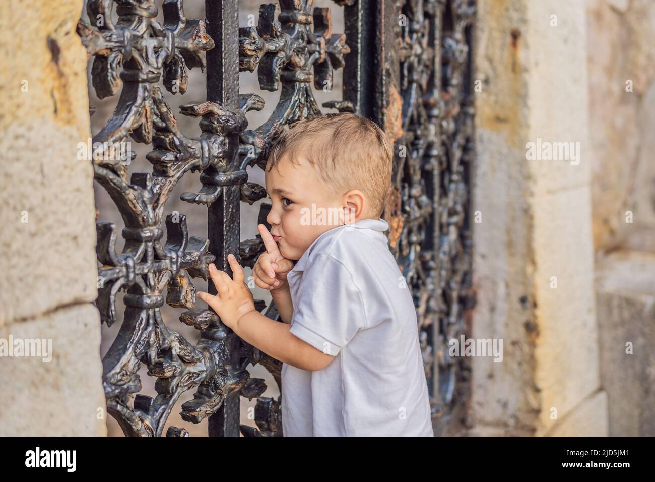 Adorable caucasian kid asking to be quiet with finger on lips. silence ...