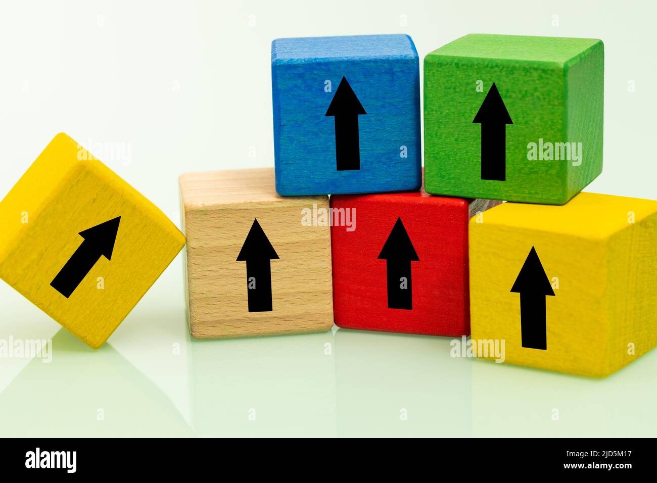 colored wooden blocks with growth arrows arranged in the shape of a ...