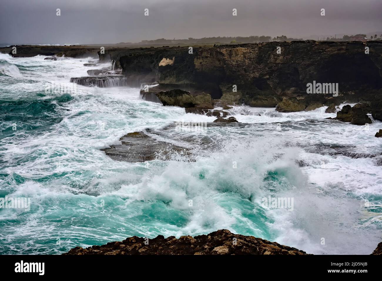 Rough ocean waves crashing against the rocky cliffs of North Point ...