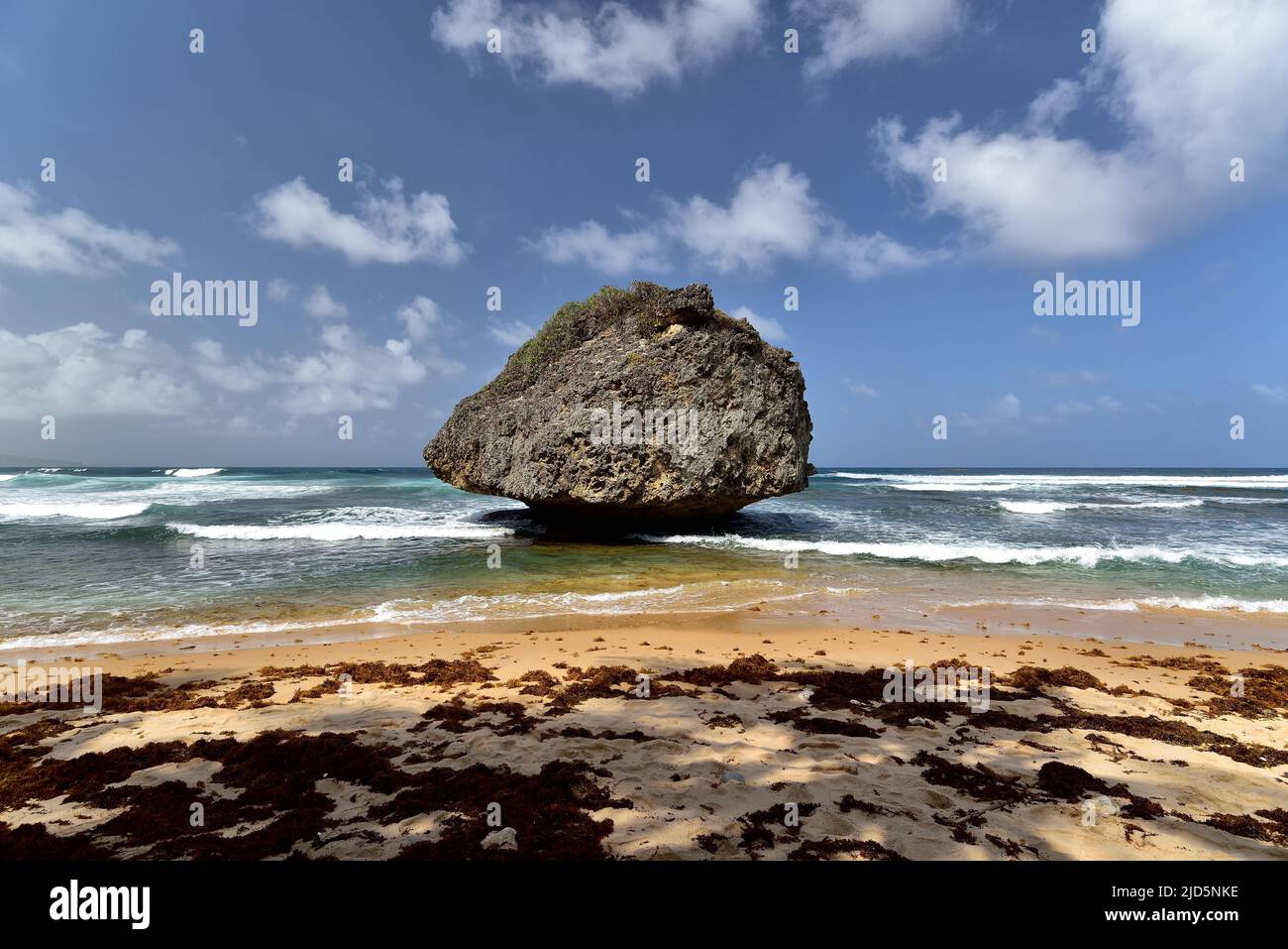 Blue sky above the huge rock on the beach of Bathsheba, East coast of ...