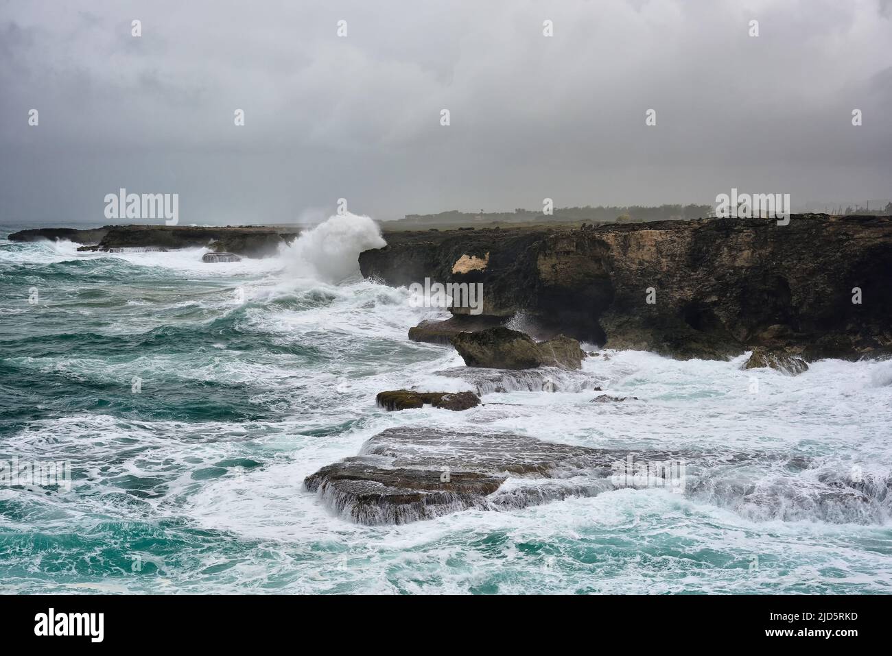 Rough ocean waves crashing against the rocky cliffs of North Point ...