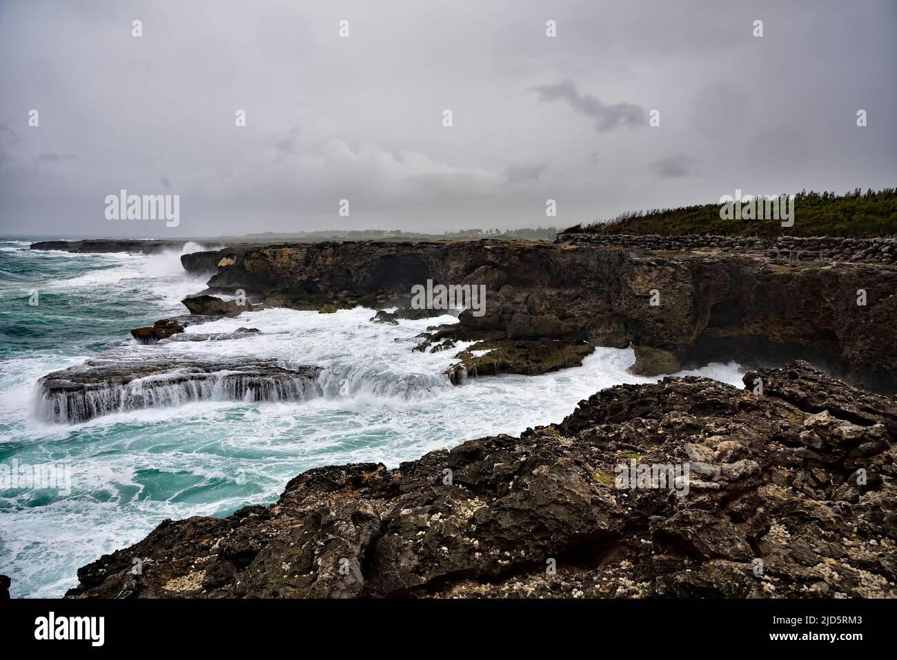 Rough ocean waves crashing against the rocky cliffs of North Point ...