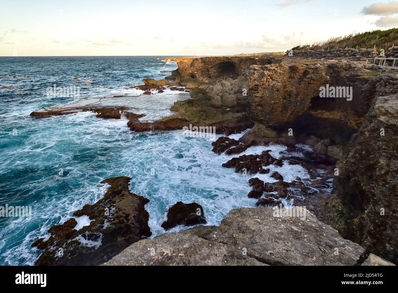 Rough ocean waves crashing against the rocky cliffs of North Point ...
