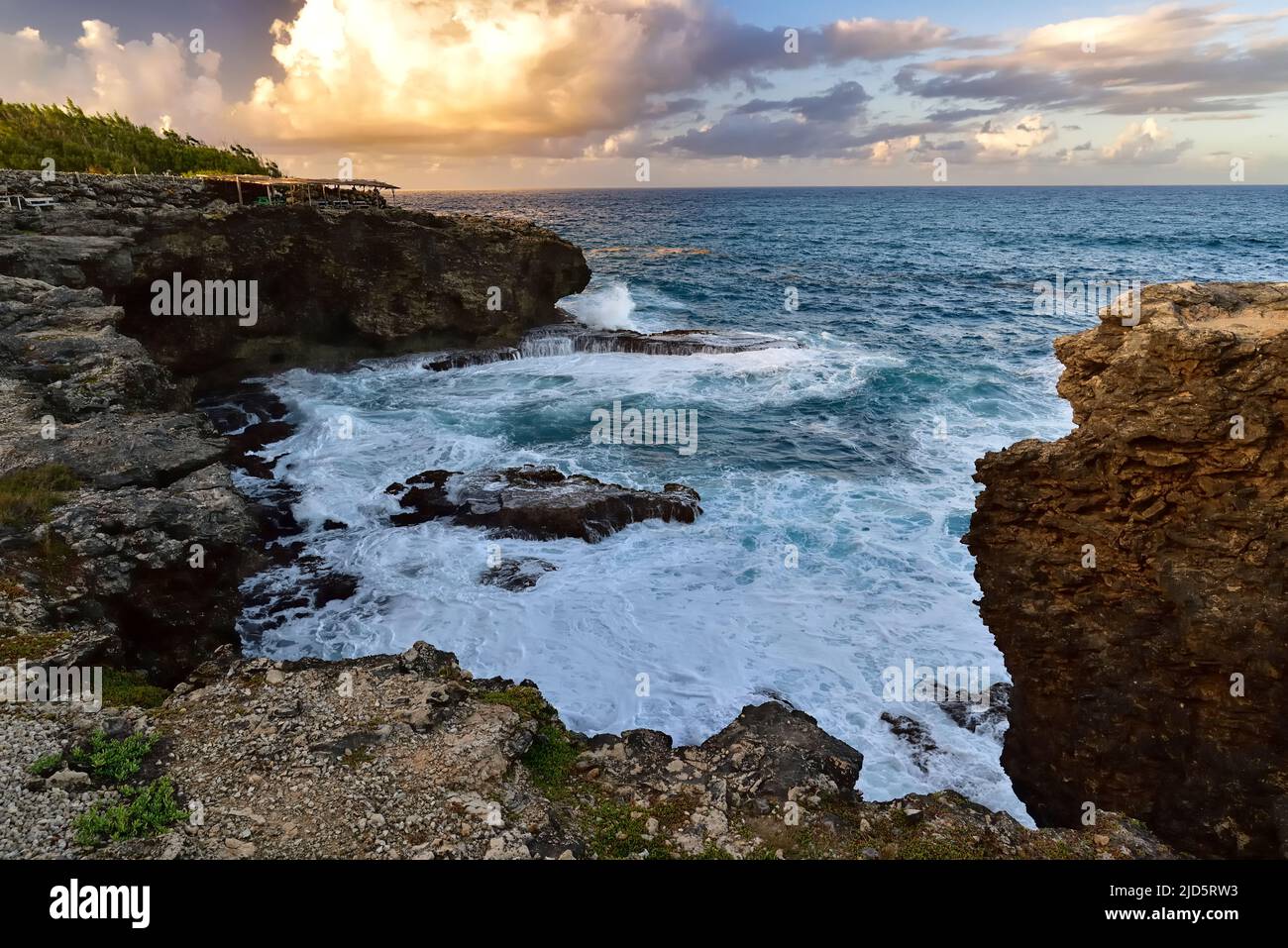 Rough ocean waves crashing against the rocky cliffs of North Point ...