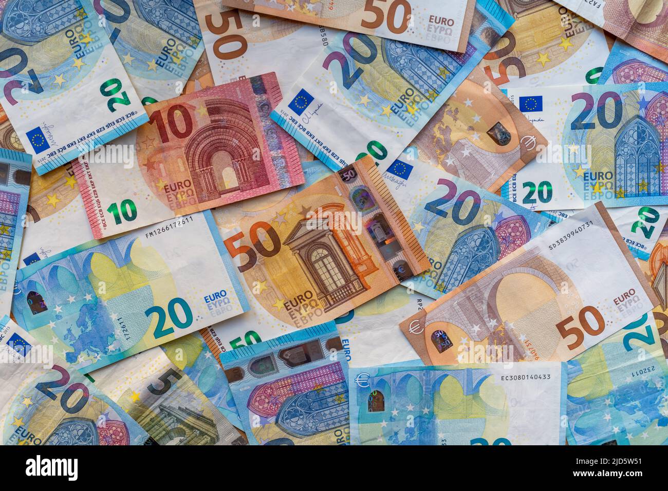 Pile of banknotes on the table in denominations of twenty euros, fifty ...