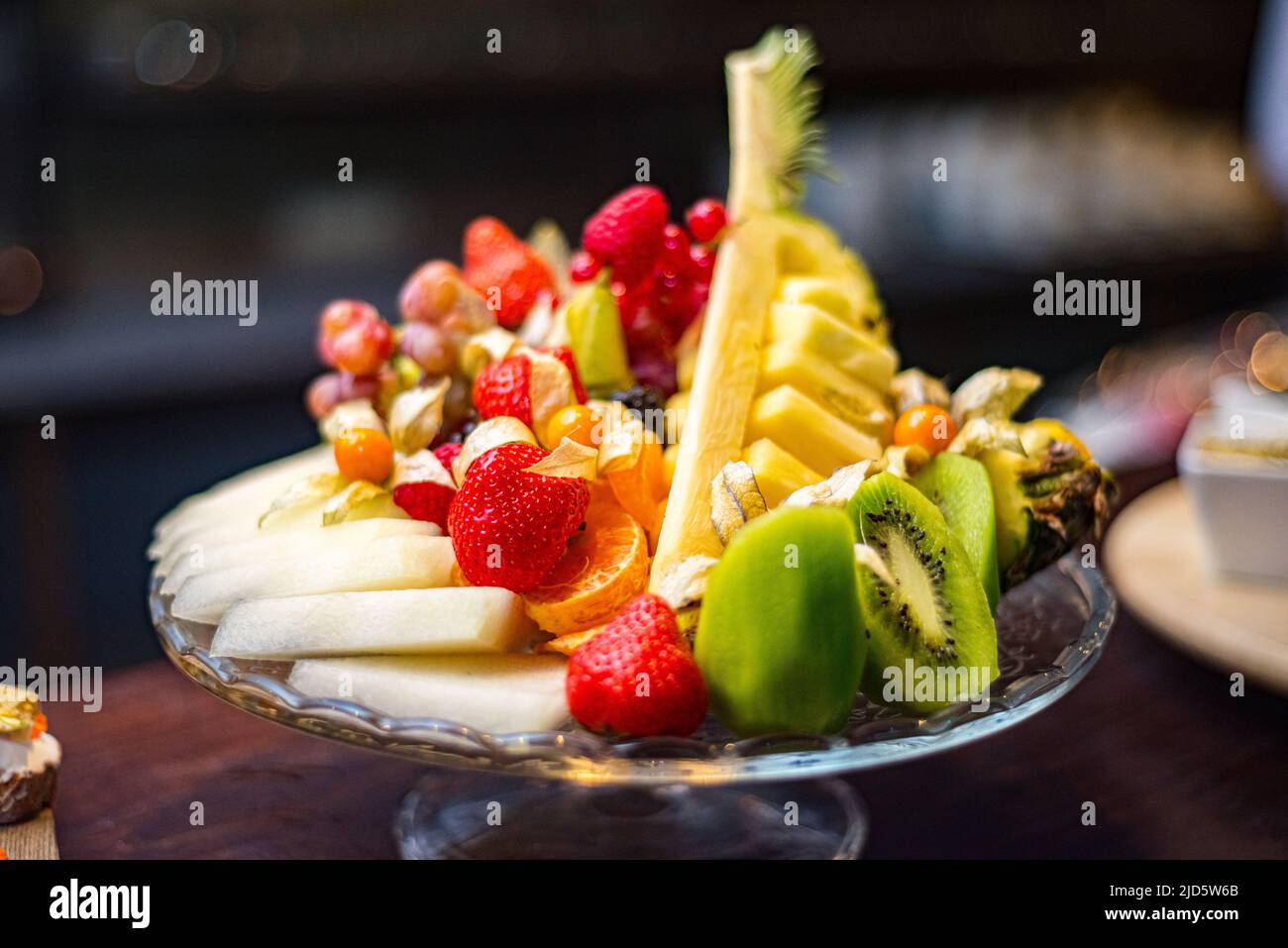Fruit plate. Stylishly lined fruit: orange slices, melon slices, grapes ...