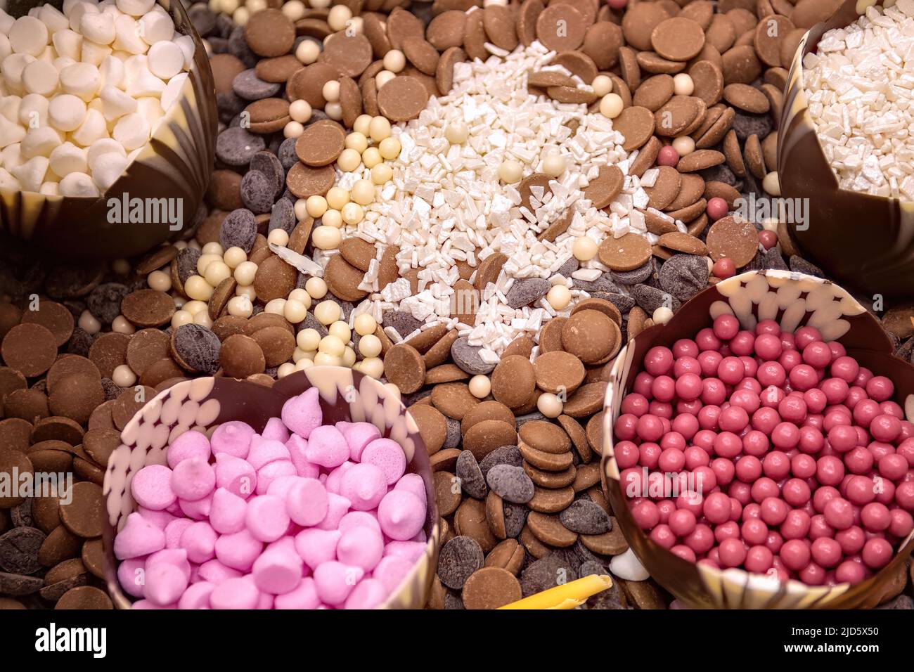 Pieces of different colored chocolate and chocolate candies top view ...