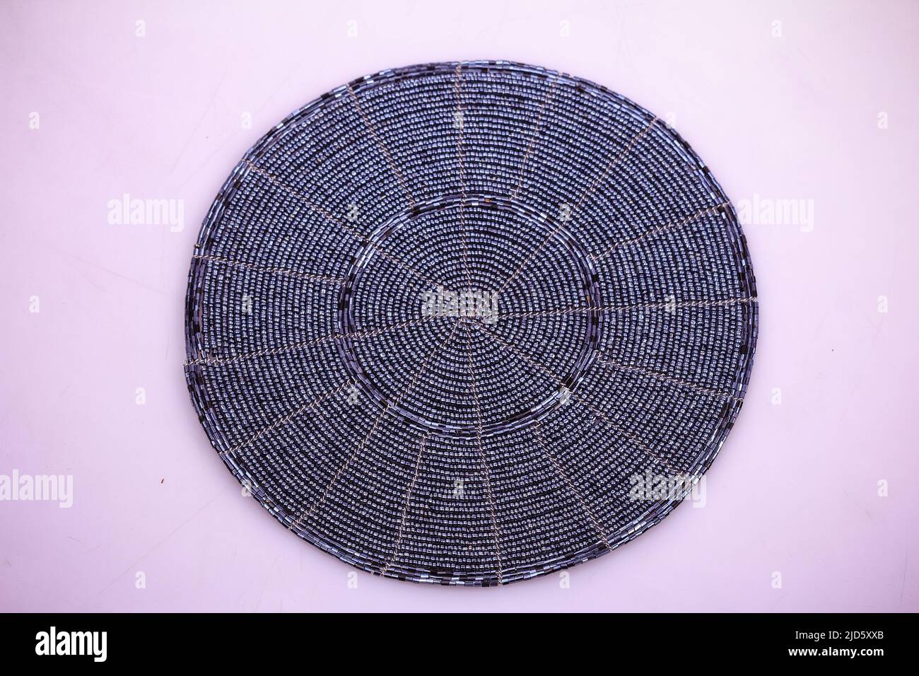 Beaded rounded table mat on white background in Kenya Stock Photo - Alamy