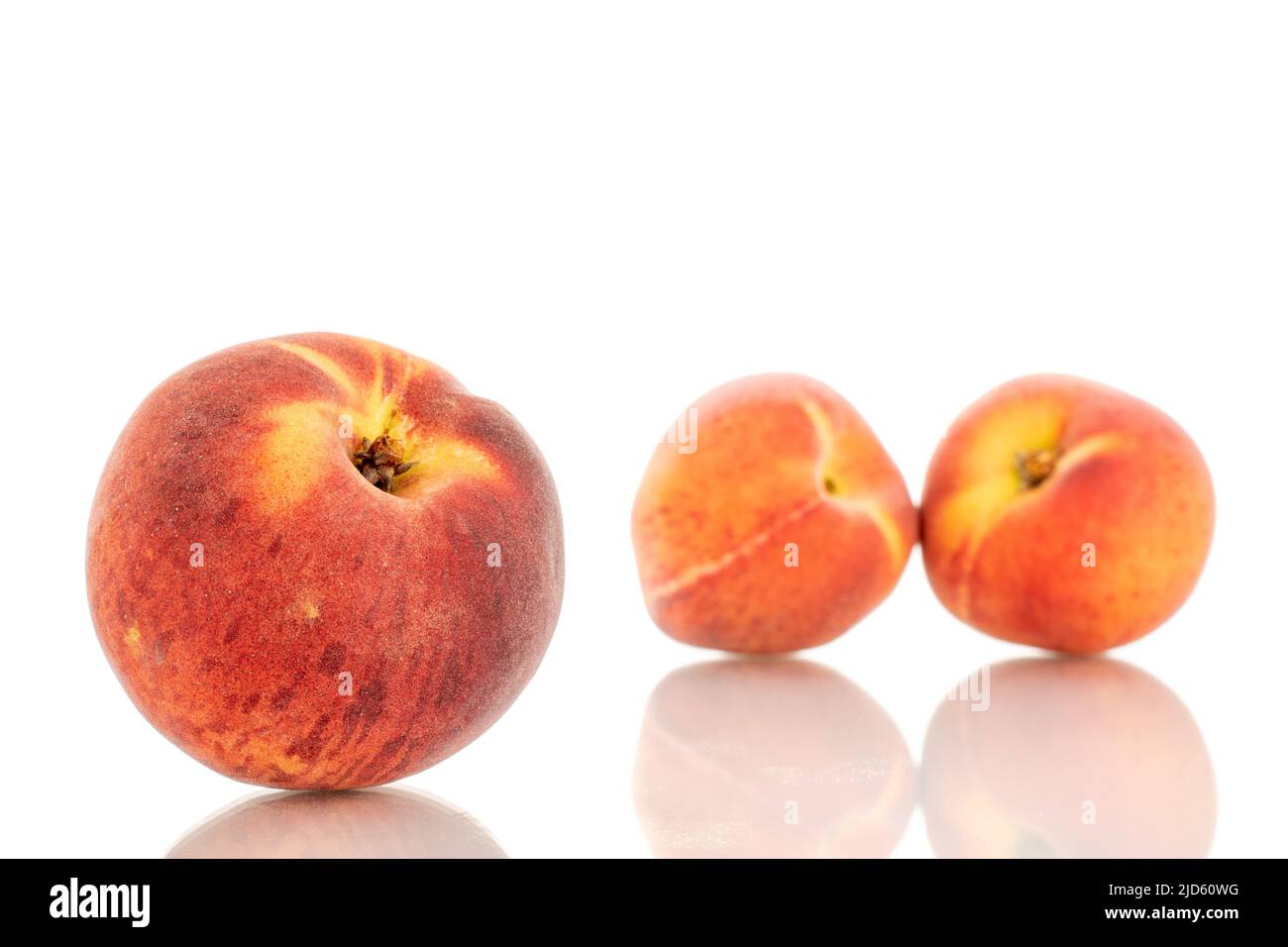 Three sweet organic peaches, close-up, isolated on white background ...