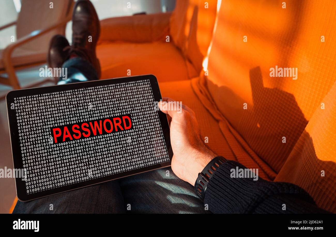 Man holding a tablet with the word Password on screen Stock Photo - Alamy