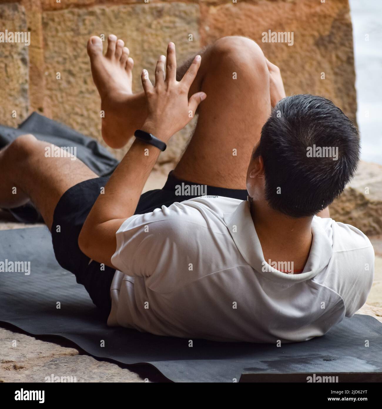 Inspired Indian young man doing yoga asanas in Lodhi Garden Park, New ...