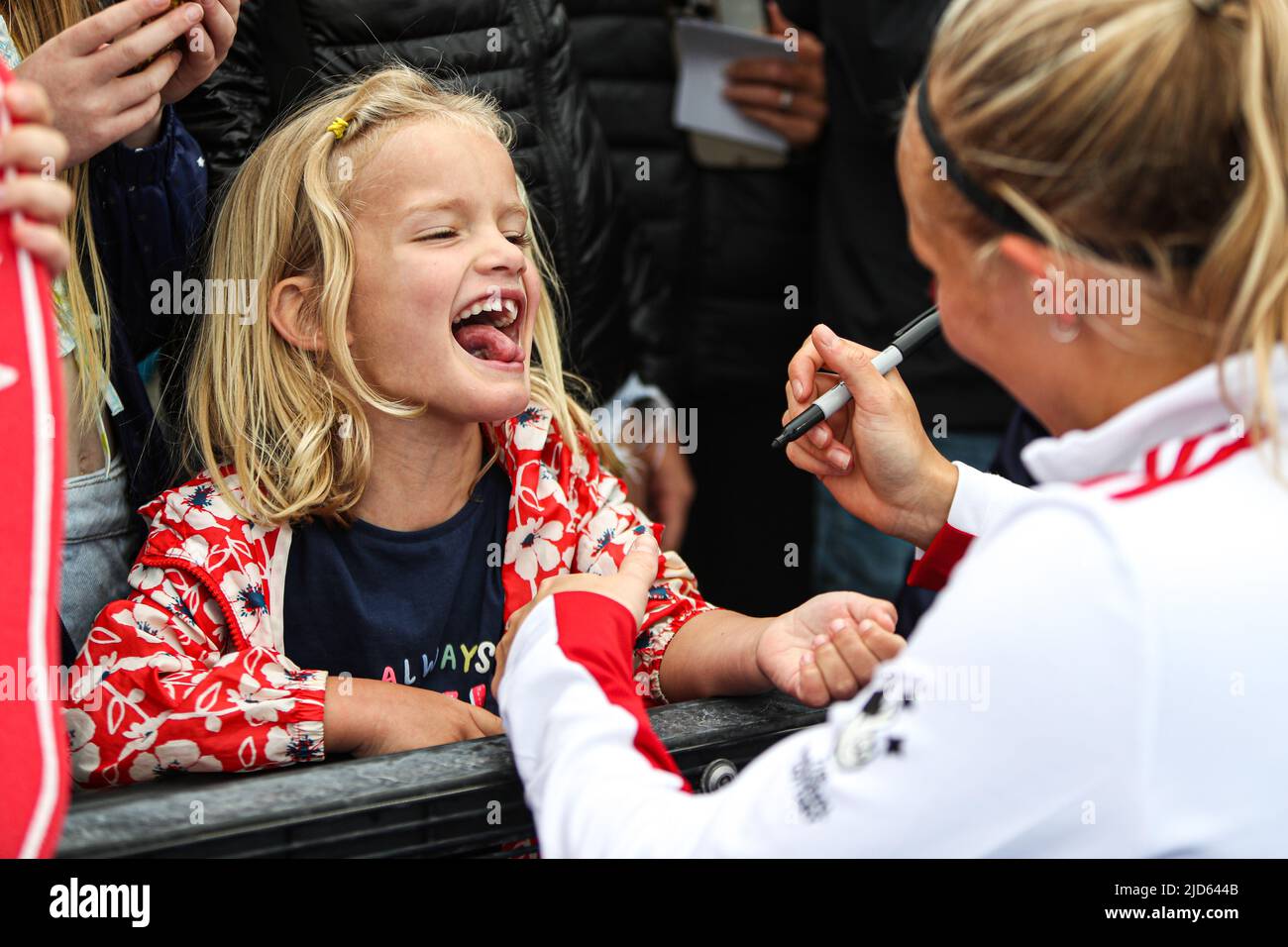 A young fan smiles as England's Lily Walker signs her arm after the ...