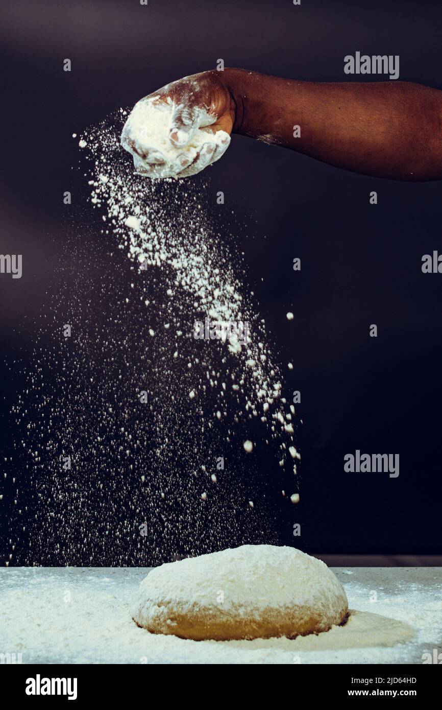 Hands splashing wheat flour kneaded Stock Photo - Alamy