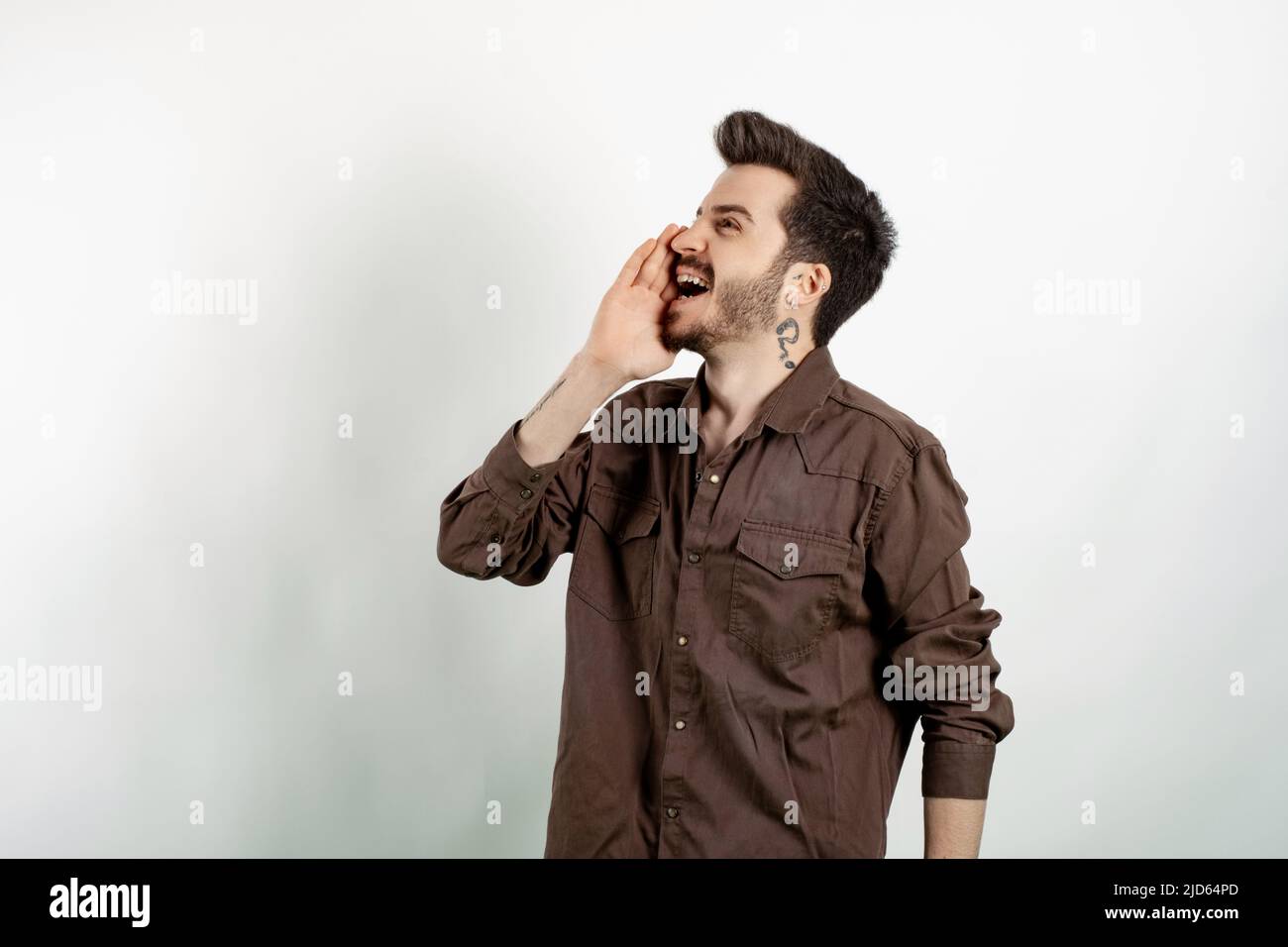 Caucasian young man wearing shirt posing isolated over white background ...