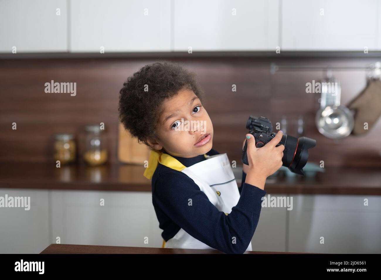 The child takes pictures with a professional camera Stock Photo - Alamy