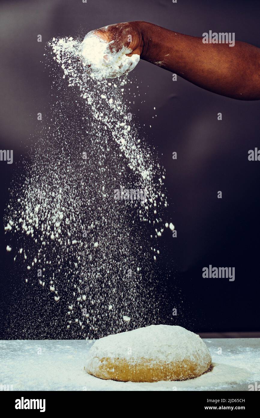 Hands splashing wheat flour kneaded Stock Photo - Alamy