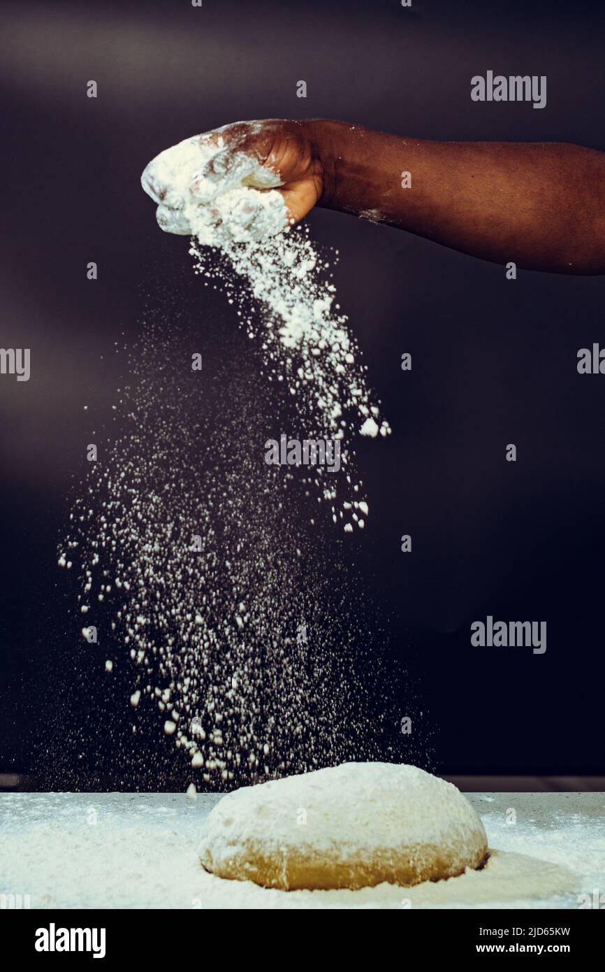 Hands splashing wheat flour kneaded Stock Photo - Alamy